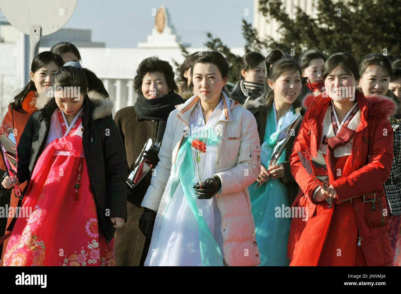 PYONGYANG, North Korea - Local people gather in front of a statue of ...