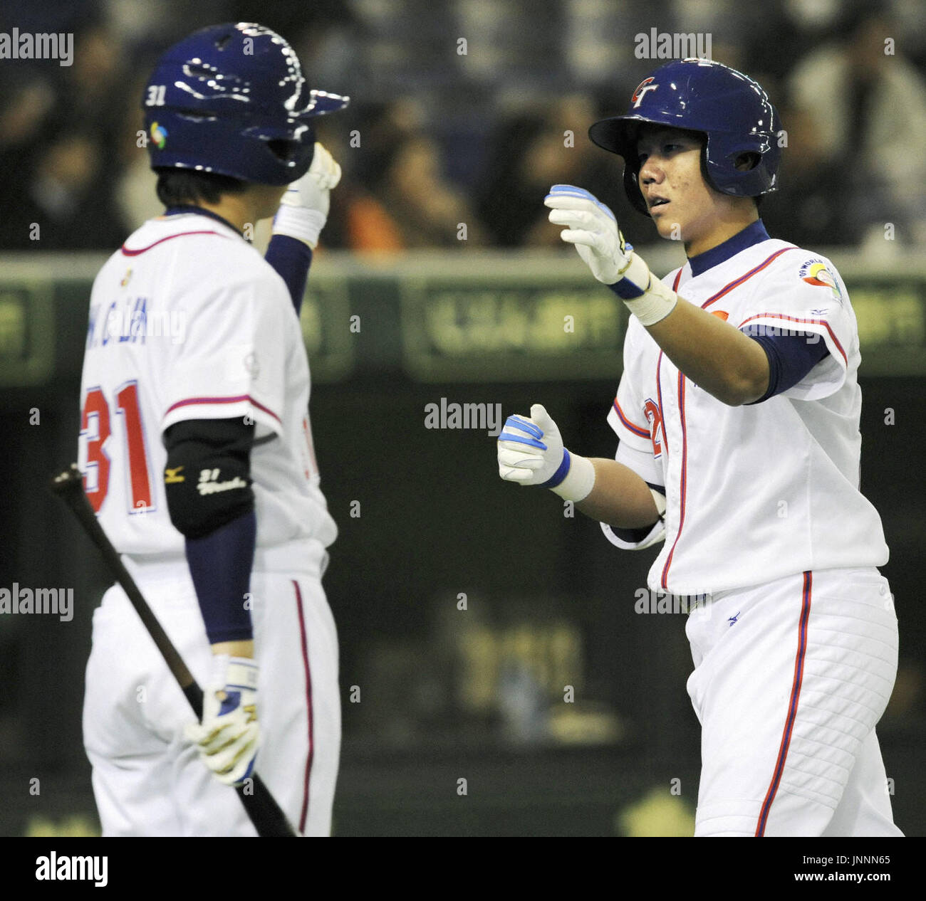 TOKYO, Japan - Taiwan infielder Lin Yi-chuan is congratulated by his ...
