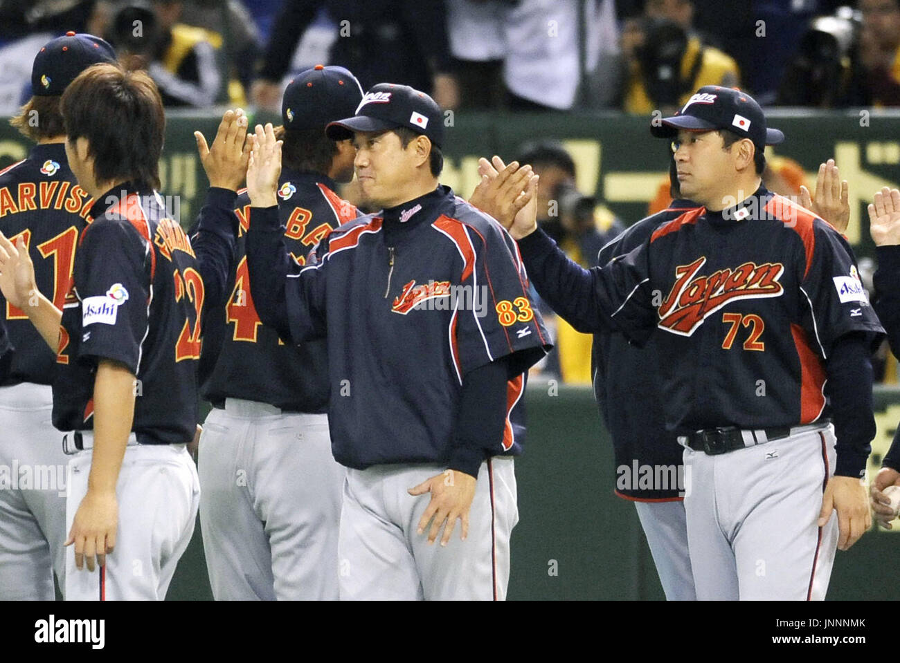 TOKYO, Japan - Japan manager Tatsunori Hara (C) exchanges high-fives ...