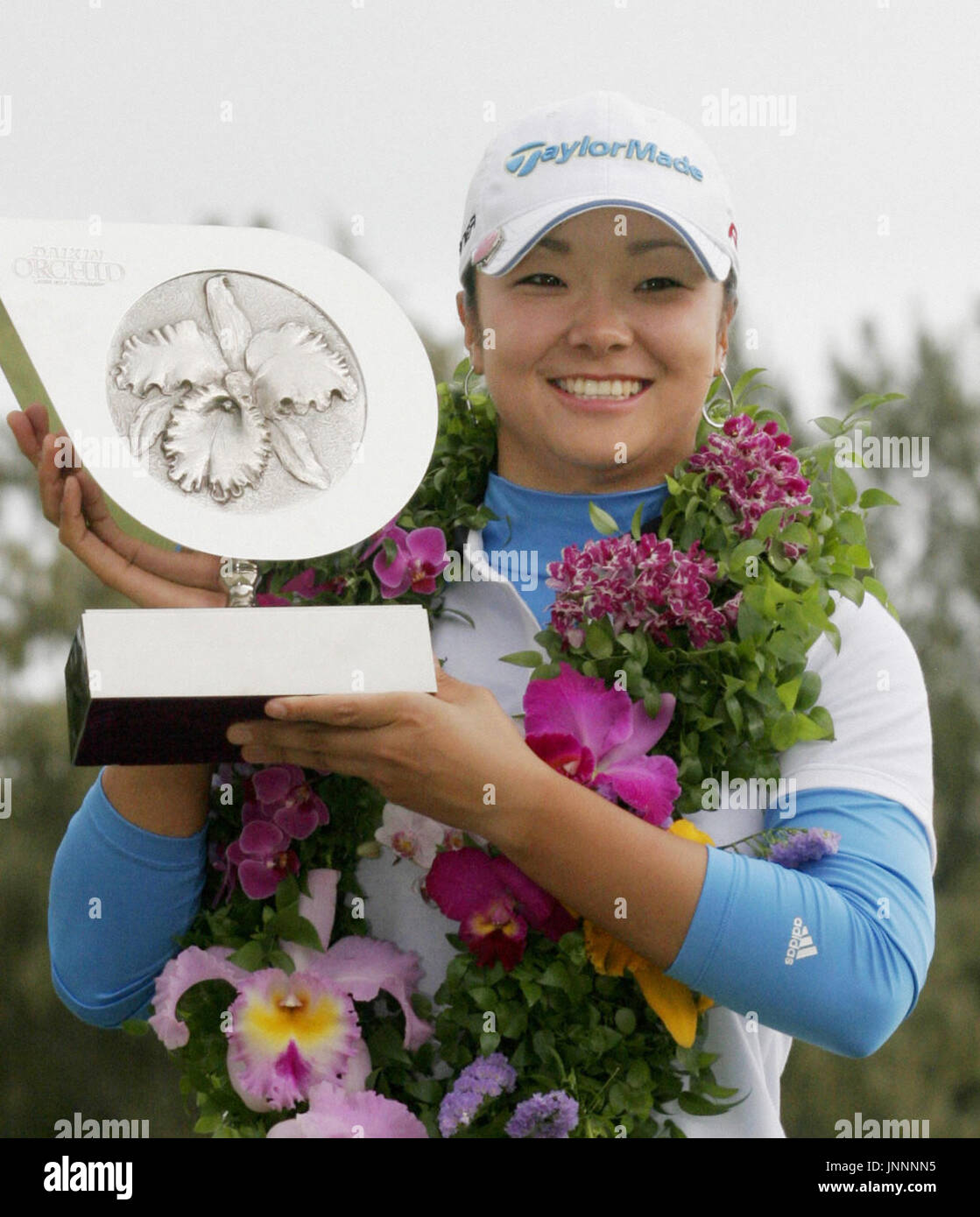 NAHA, Japan - Yuko Mitsuka poses with the winner's trophy after winning ...