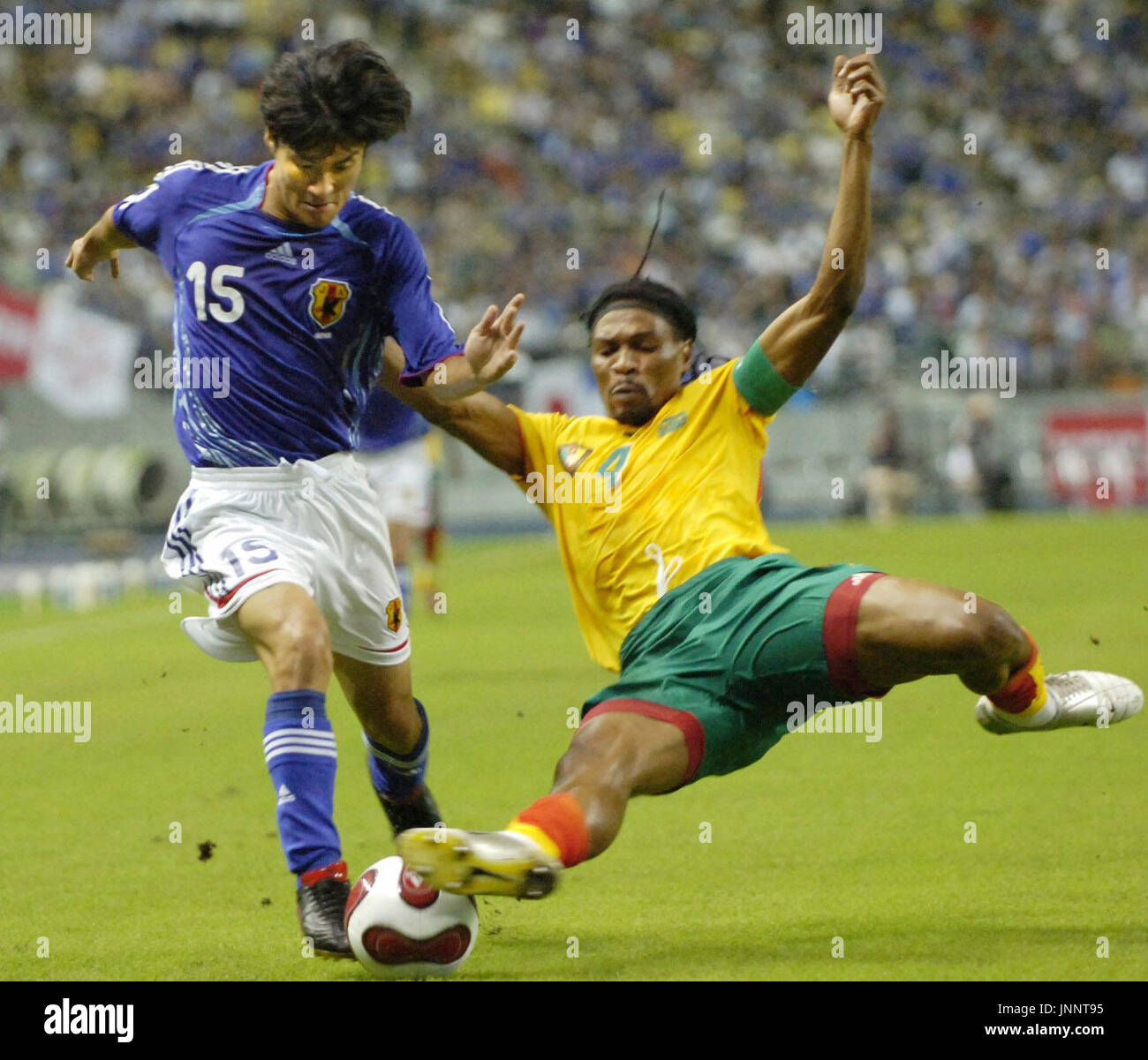 OITA, Japan - Japan forward Tatsuya Tanaka (L) and Cameroon defender ...