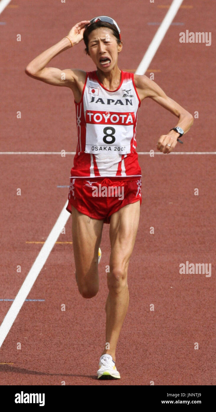 OSAKA, Japan - Japan's Reiko Tosa crosses the finish line in third ...