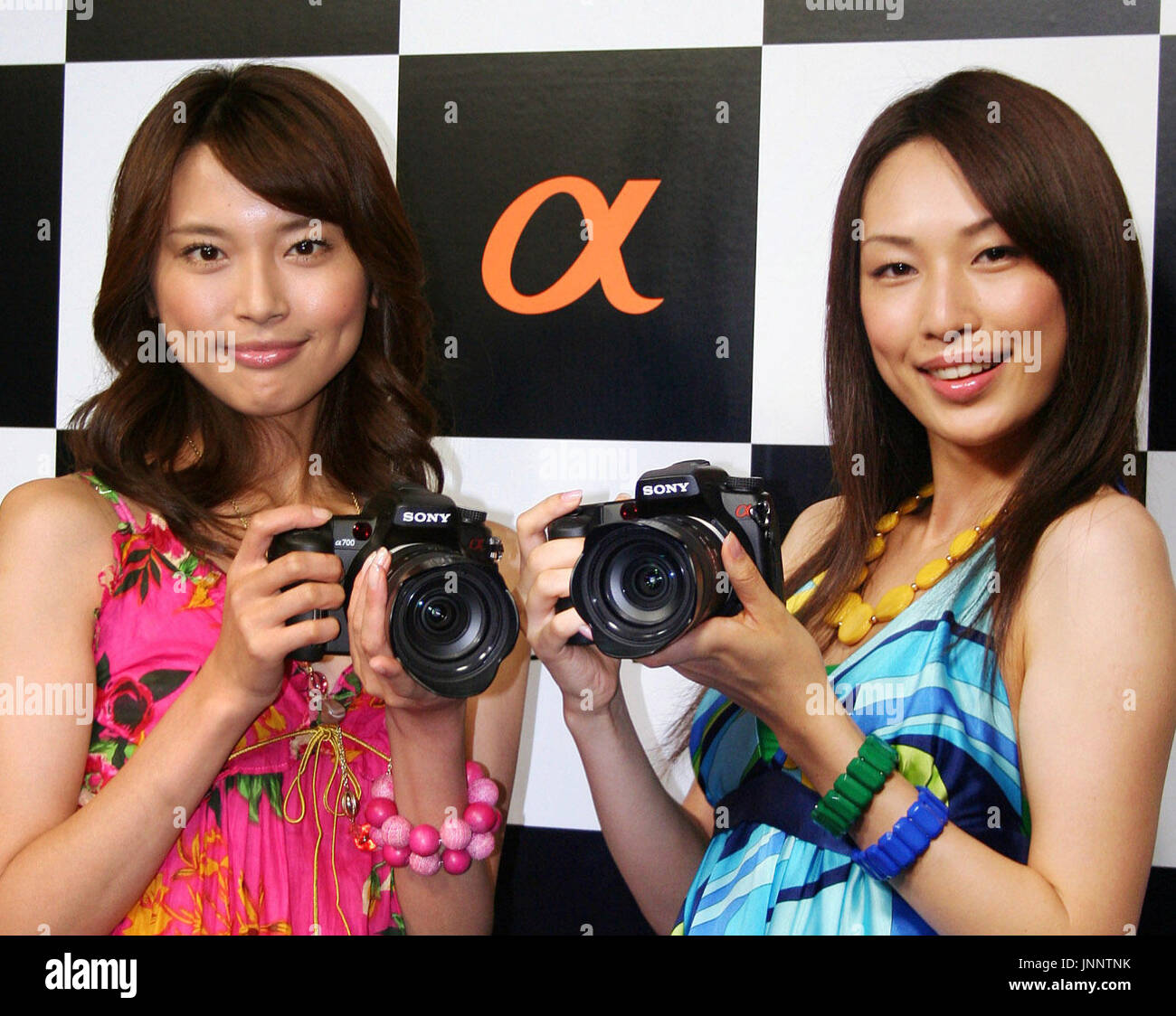TOKYO, Japan - Models pose with Sony Corp.'s new digital single-lens ...