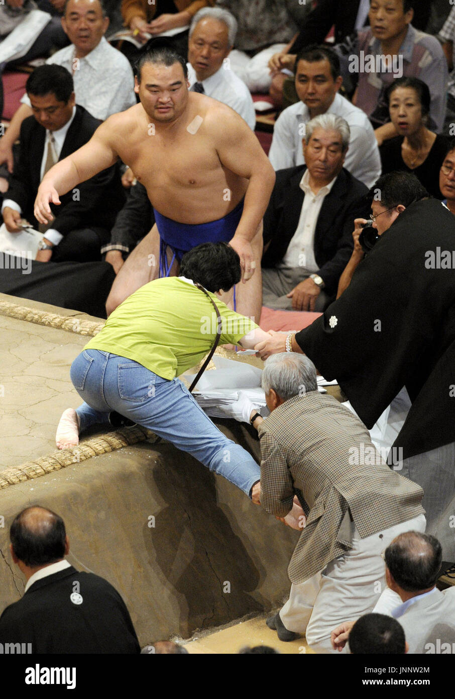 TOKYO, Japan - A woman attempting to climb up into the ring during the ...