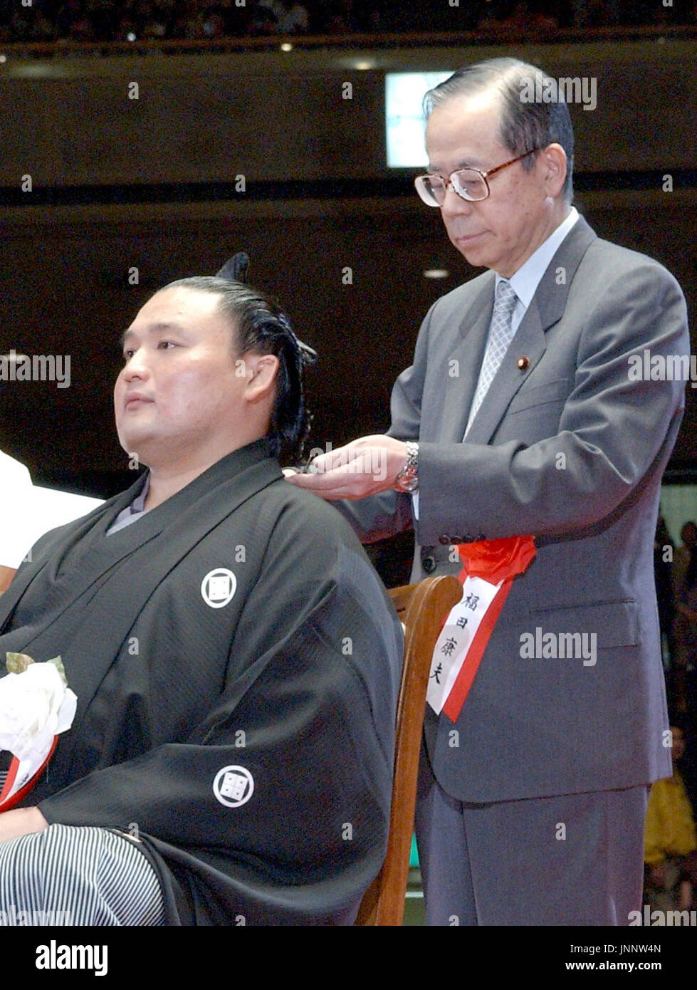 TOKYO, Japan - Yasuo Fukuda (R) attends a topknot cutting ceremony for ...