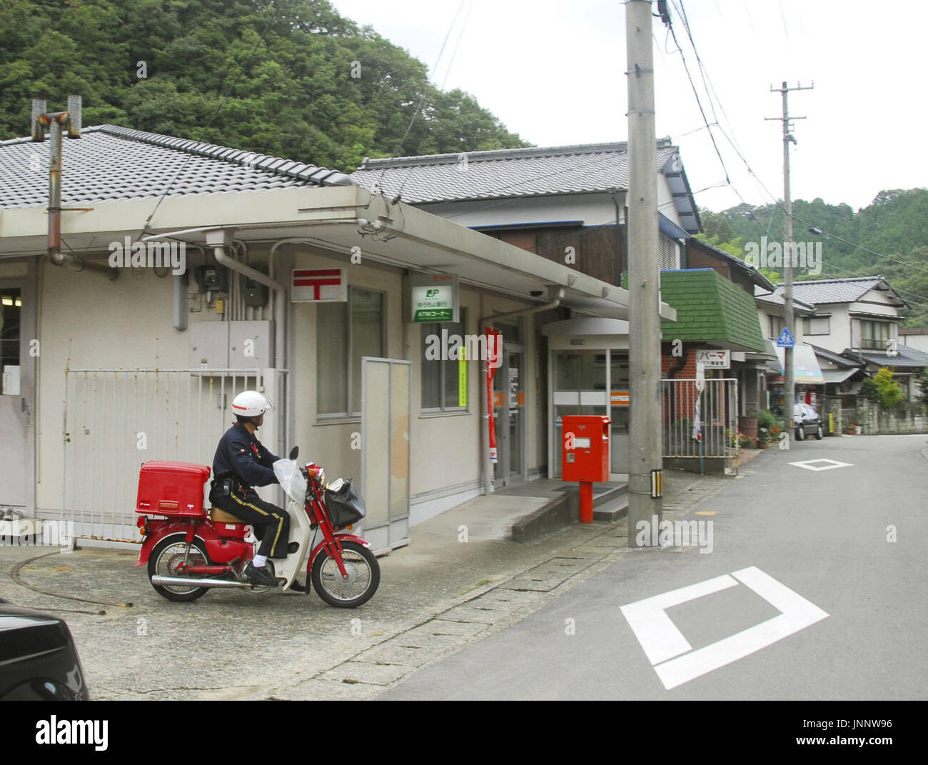 TAKAMATSU, Japan - A Japan Post Service staffer wearing a new uniform ...
