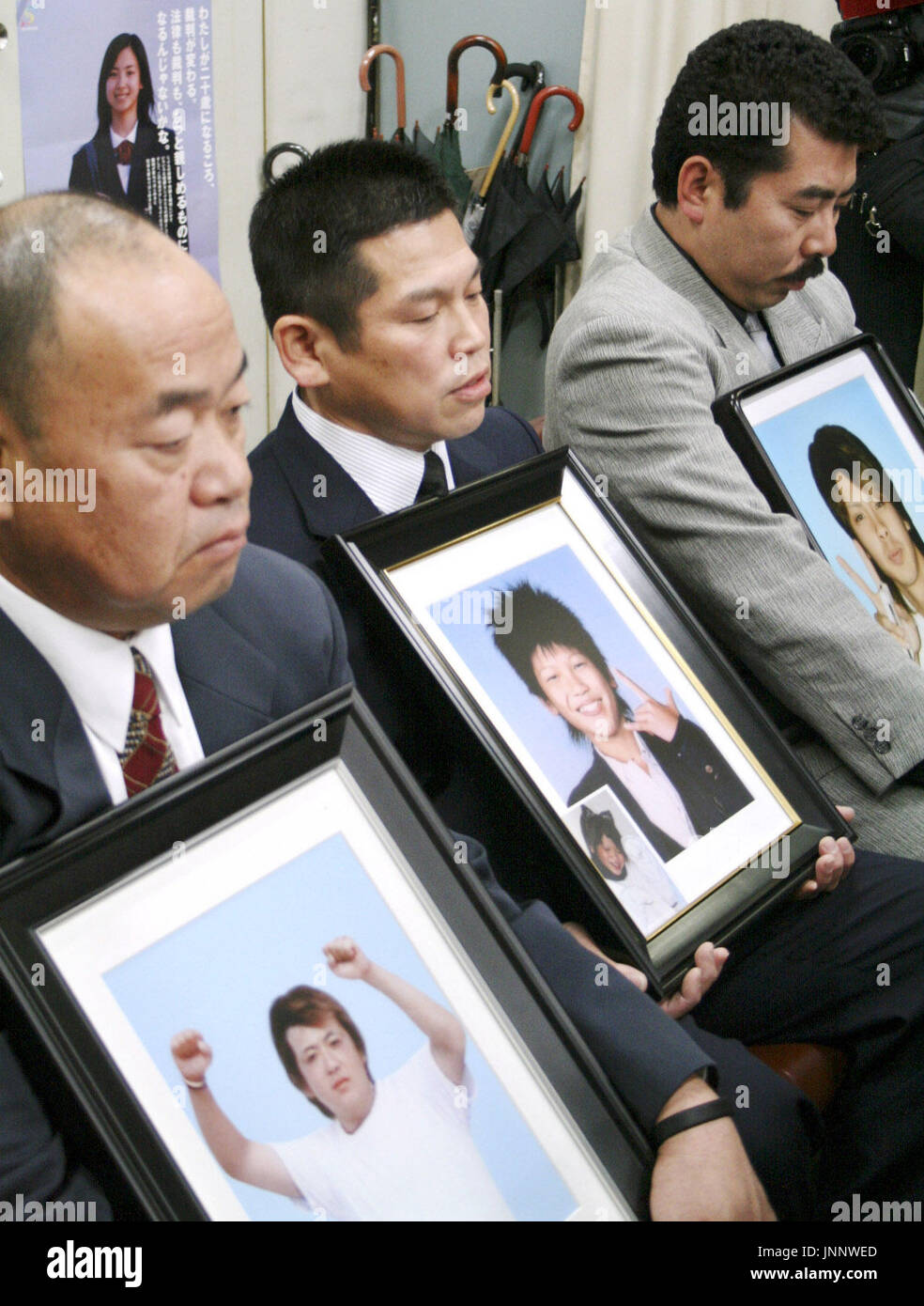 KOBE, Japan - Holding the photographs of three victims who died in a ...