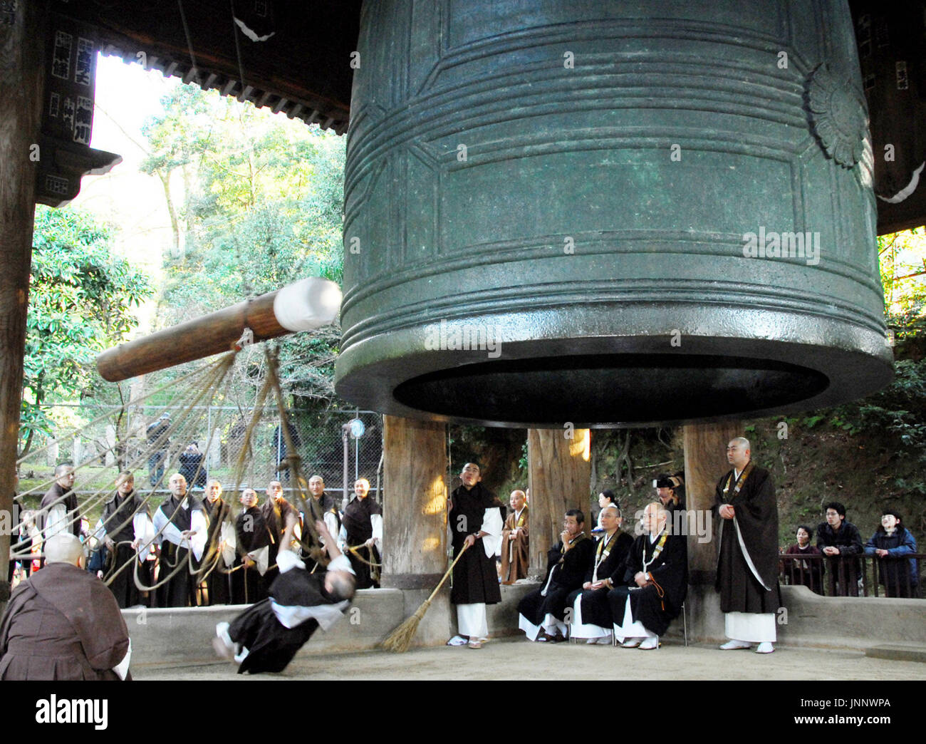 KYOTO, Japan - A team of Buddhist priests toll the huge bronze bell at ...