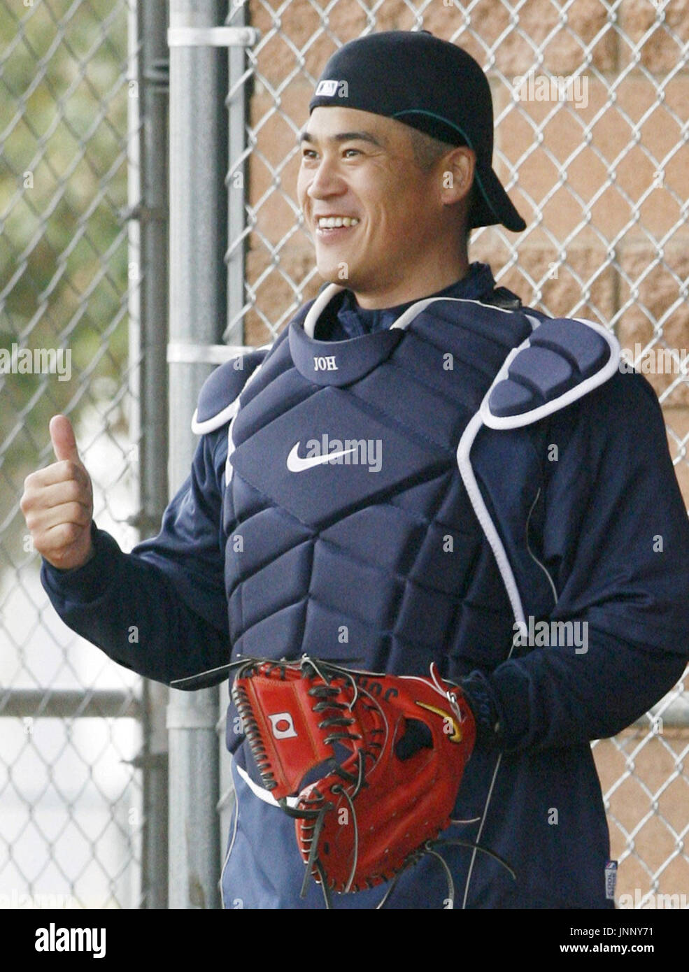 PEORIA, United States - Seattle Mariners catcher Kenji Jojima puts his ...