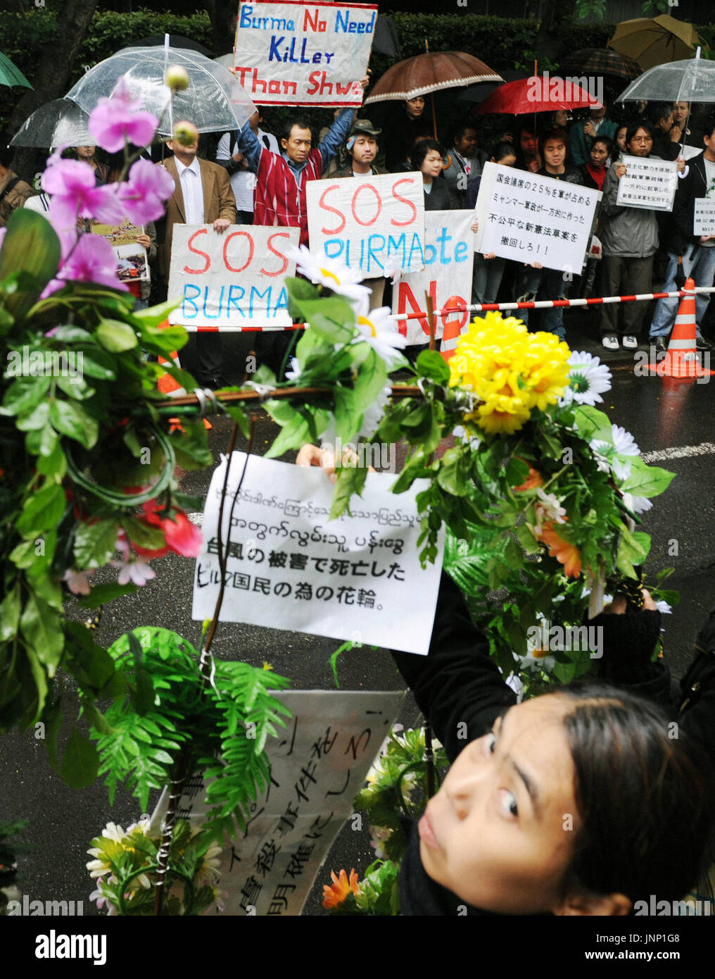 TOKYO, Japan - Myanmarese people offer flowers in front of the Myanmar ...