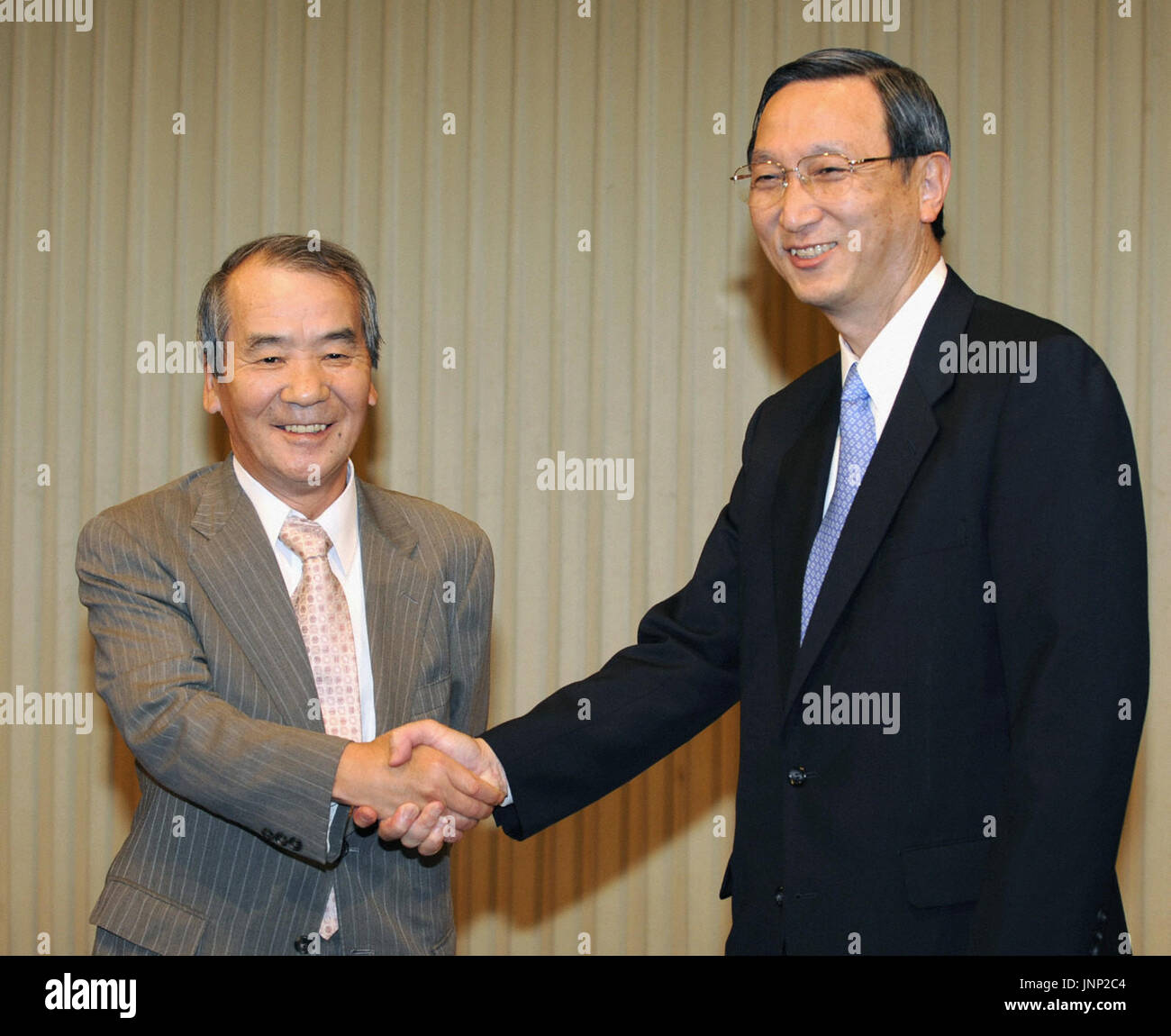 TOKYO, Japan - Masao Kimiwada (L), president of TV Asahi Corp., and ...
