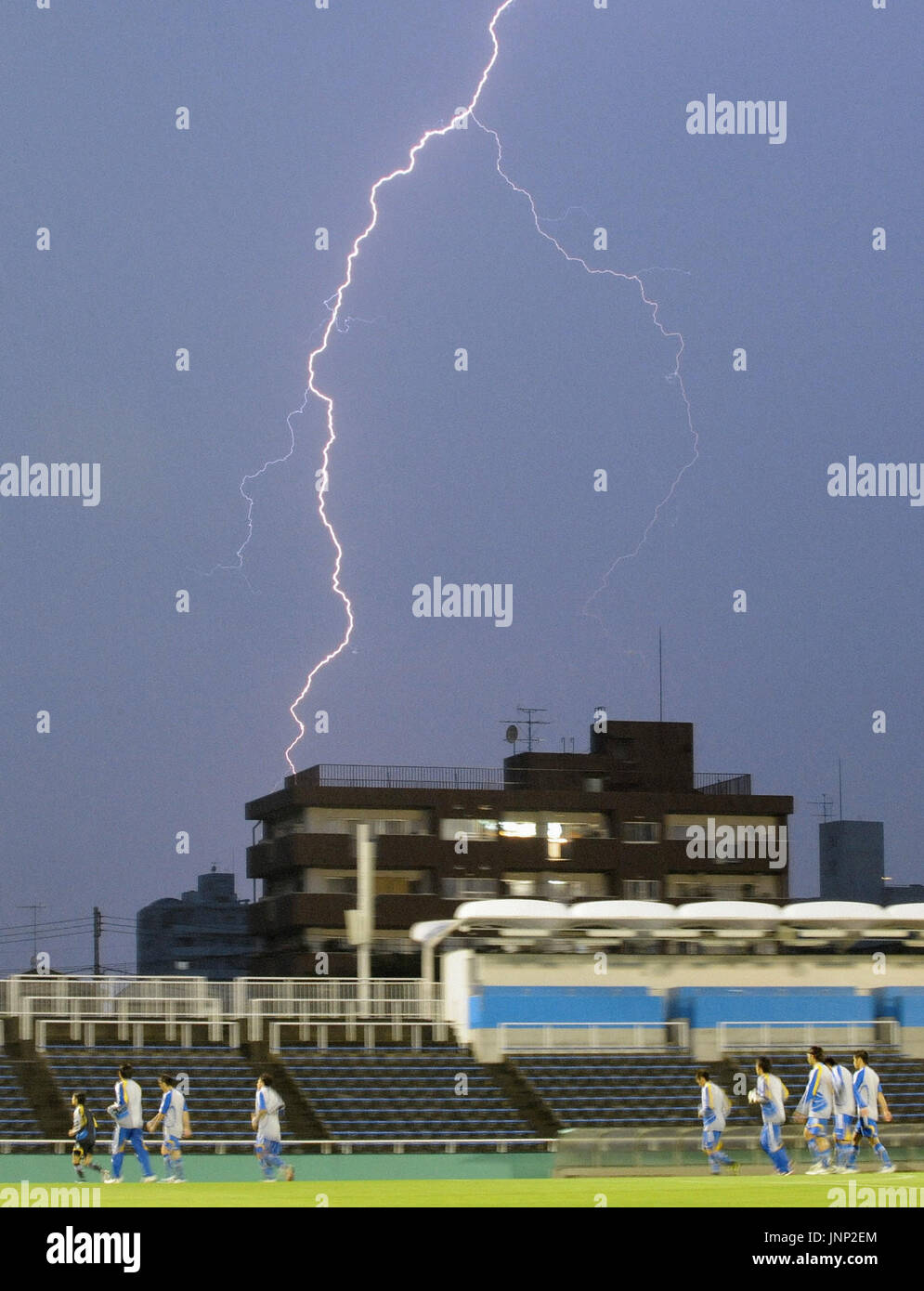 TOKYO, Japan - Lightning strikes as members of Japan's Under-23 soccer ...