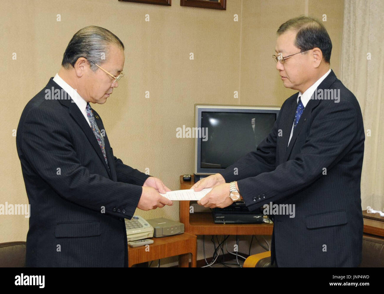 OMAEZAKi, Japan - Chubu Electric Power President Toshio Mita hands to ...
