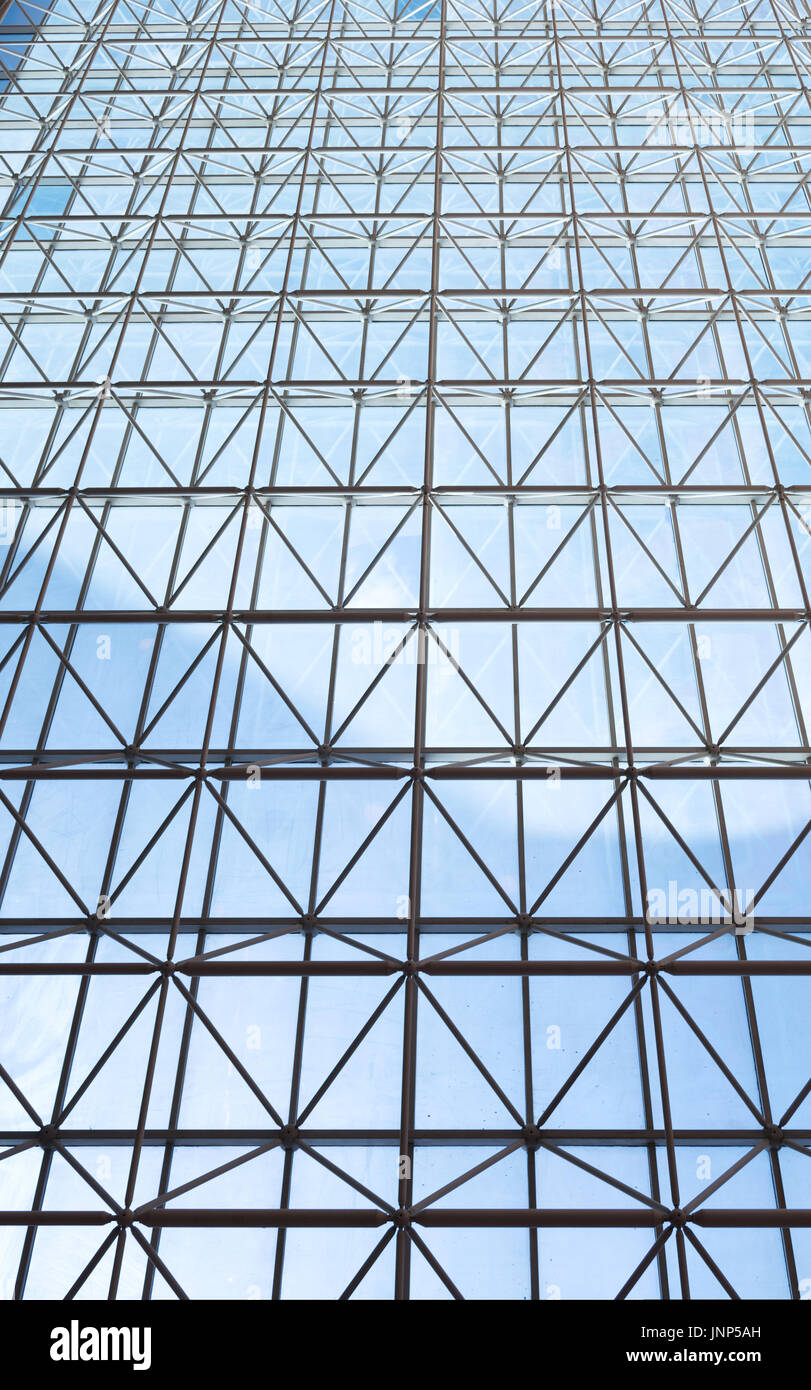 Contemporary steel structure and transparent glass roof revealing blue ...