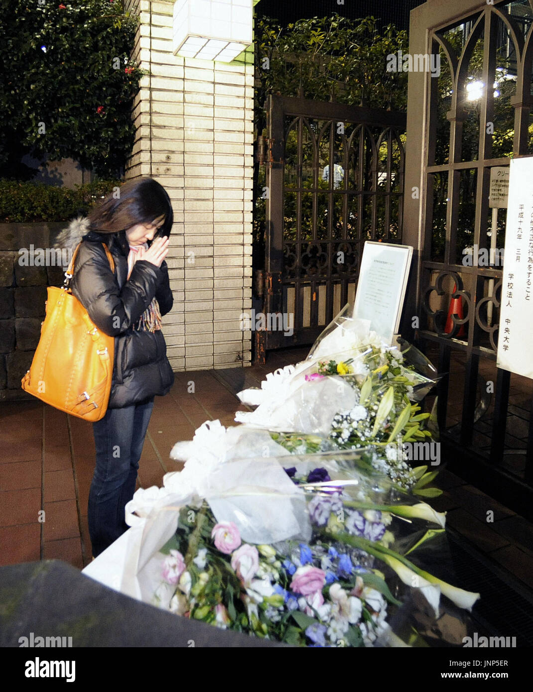 TOKYO, Japan - A student prays Jan. 15 for Hajime Takakubo, professor ...