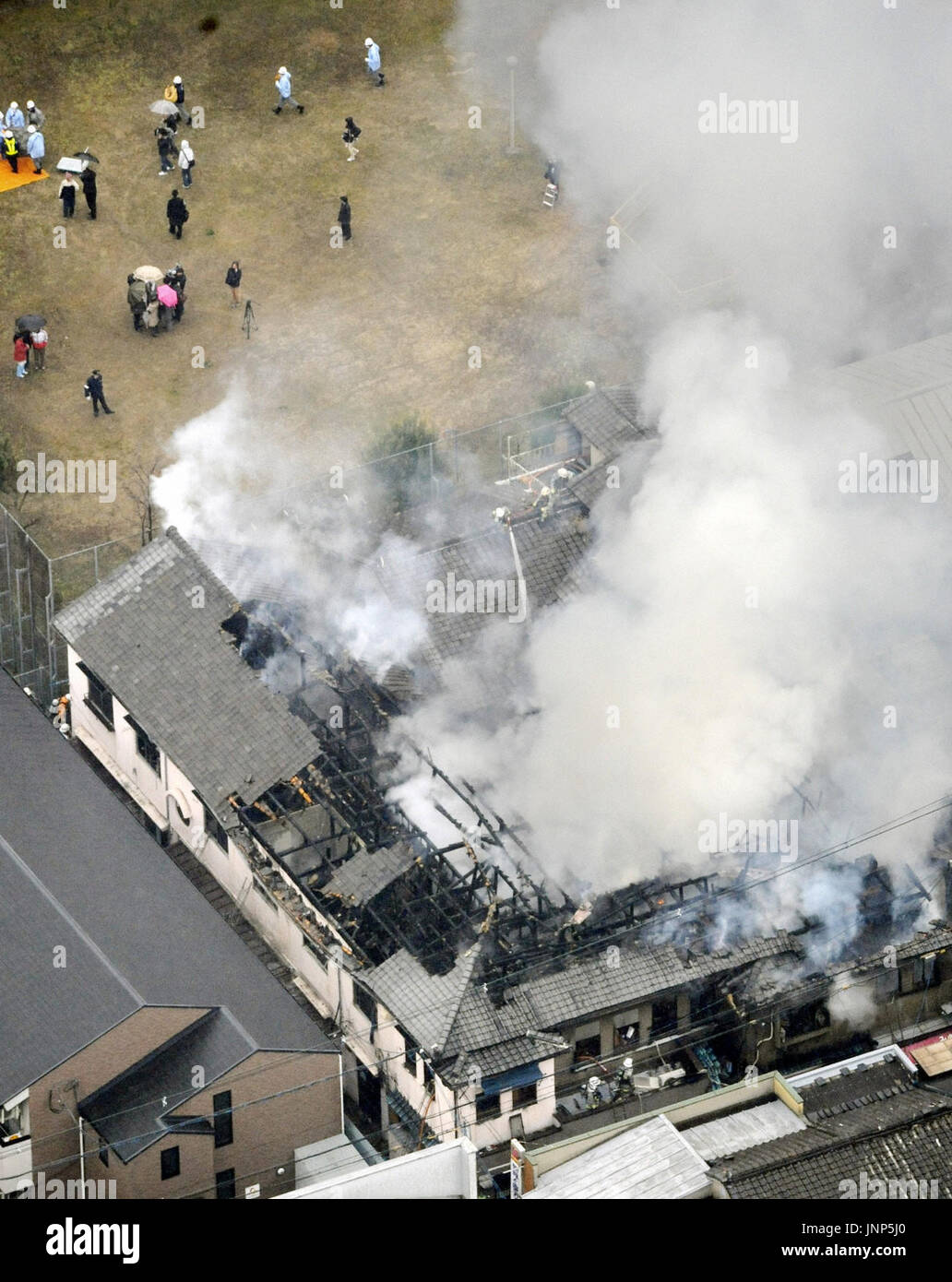 OSAKA, Japan - Photo shows a fire burning a wooden apartment building ...