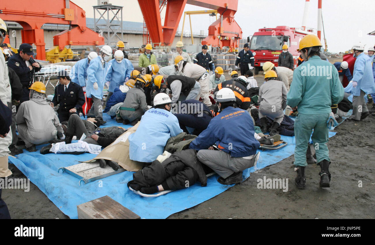 OITA, Japan - Firefighters and police officers take care of victims of ...