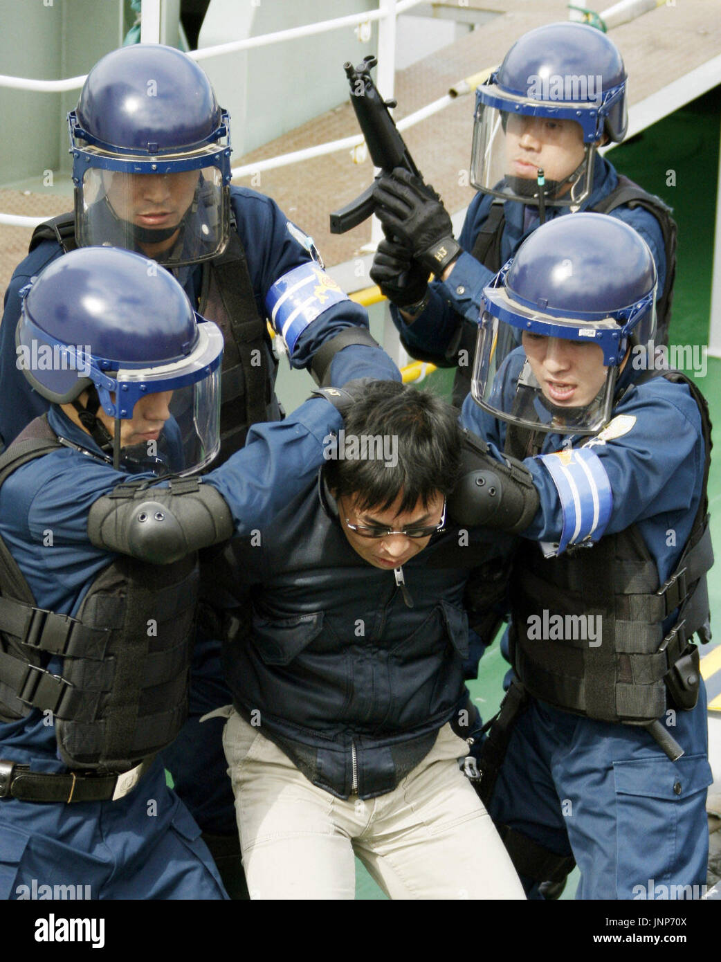 SAPPORO, Japan - Police officers capture a suspected terrorist during ...