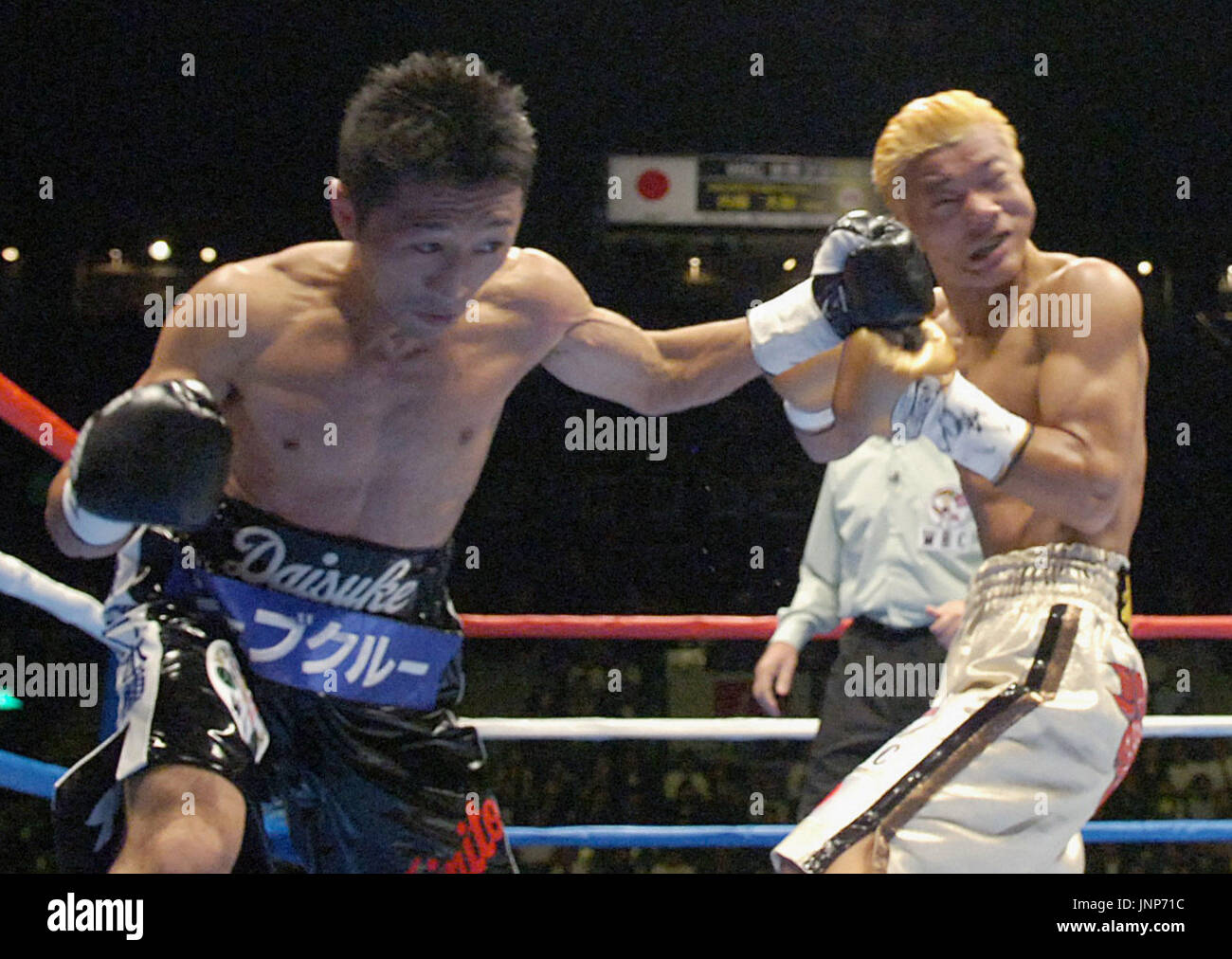TOKYO, Japan - Champion Daisuke Naito (L) punches challenger Daiki ...