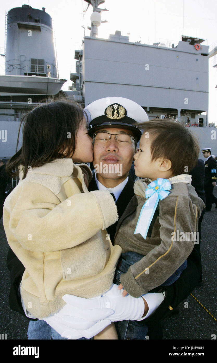 TOKYO, Japan - A Maritime Self-Defense Force officer gets kisses from ...