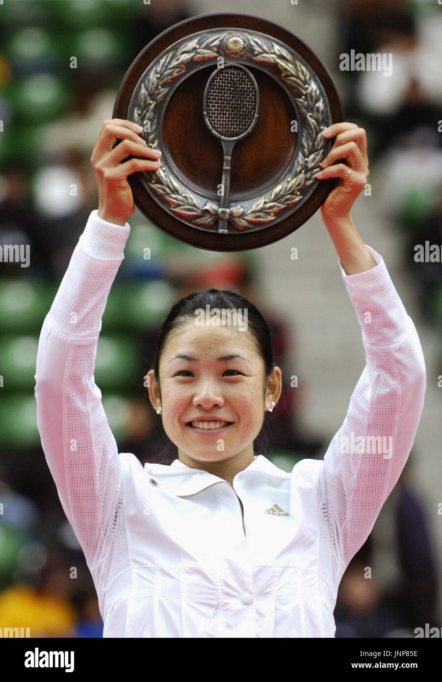 TOKYO, Japan - Top seed Aiko Nakamura lifts her champion's plate at the awards ceremony on Nov ...