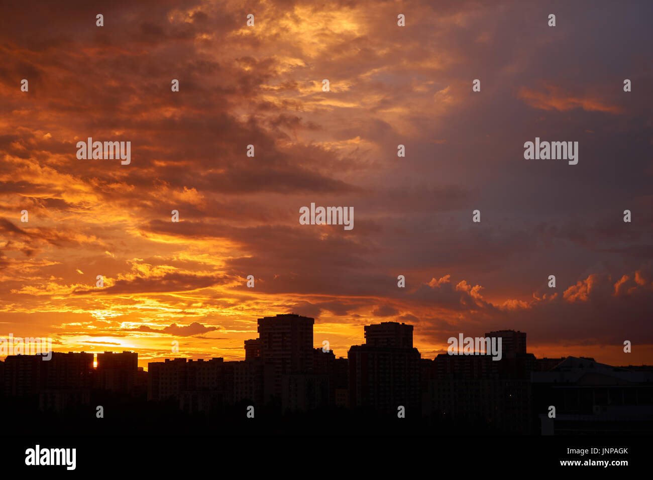 Beautiful sunset scene in the city with dark silhouettes of buildings ...