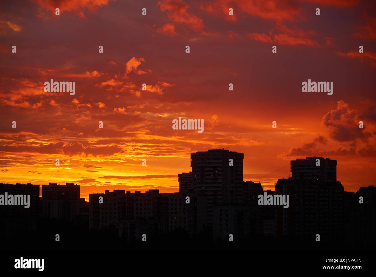 Beautiful sunset scene in the city with dark silhouettes of buildings ...