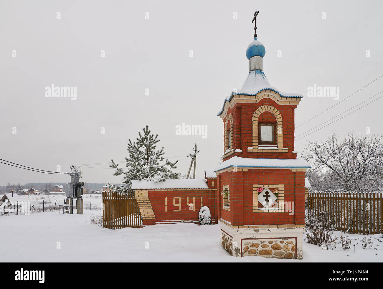 Winter view of red brick chapel and monument to soviet warriors who ...