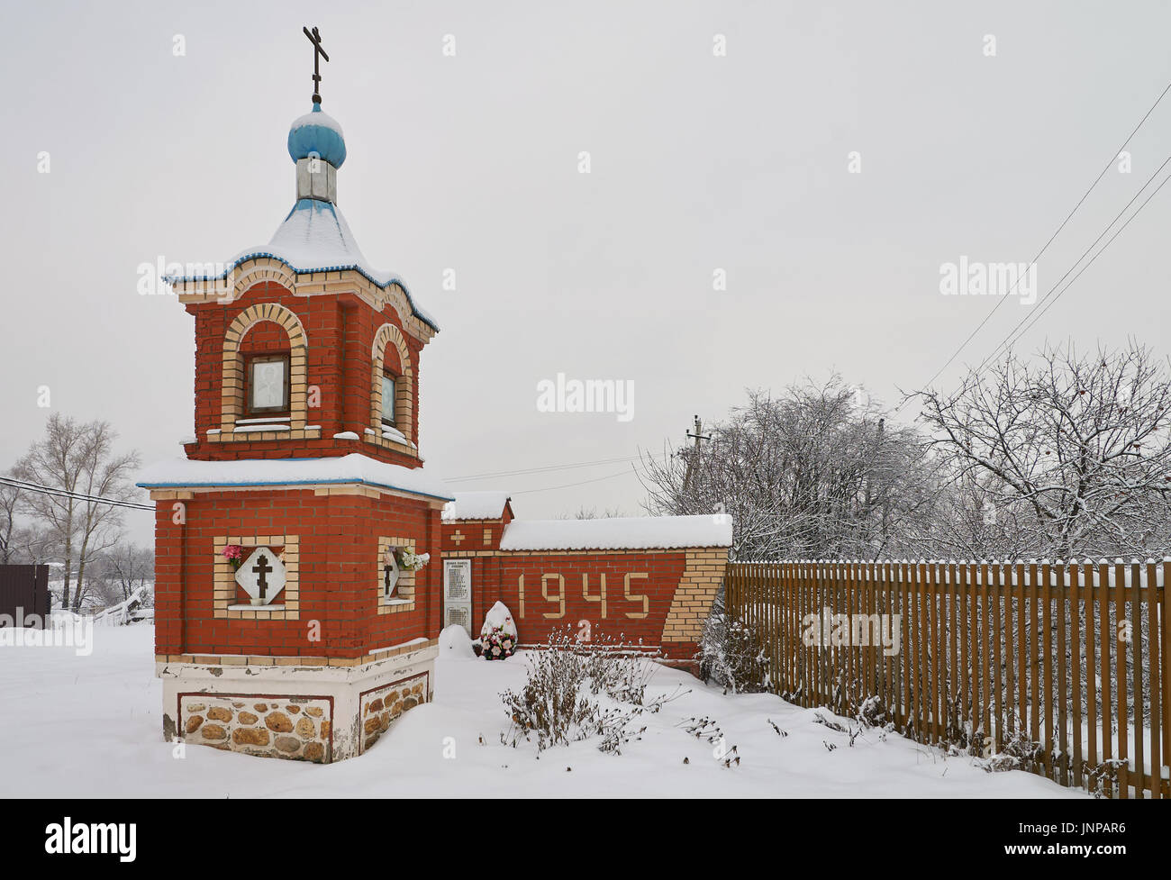 Winter view of red brick chapel and monument to soviet warriors who ...