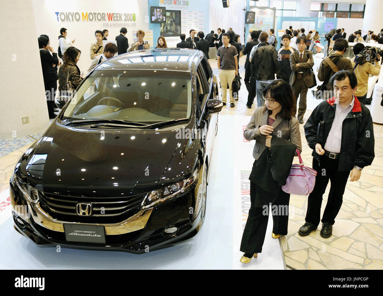 TOKYO, Japan - Visitors look at a car on display at the Tokyo Motor ...