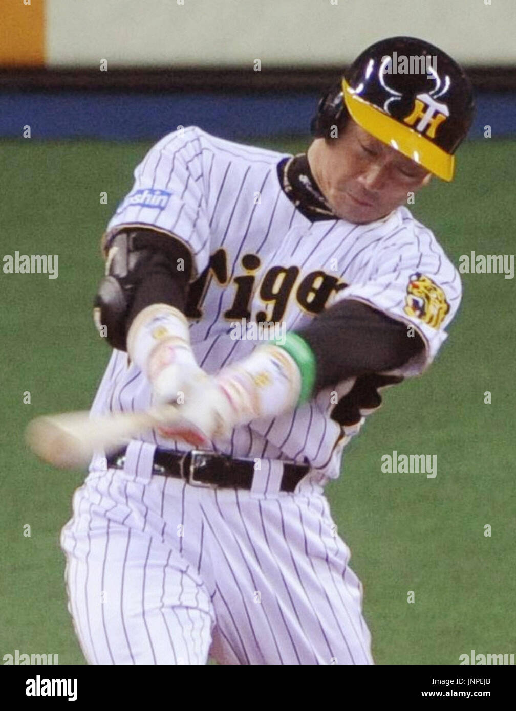OSAKA, Japan - Tigers' Tomoaki Kanemoto opens the scoring with a run ...