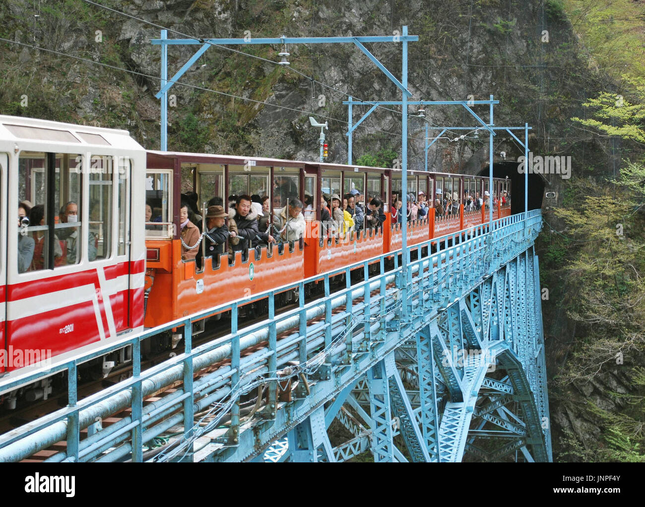 TOYAMA, Japan - Tourists enjoy the scenic view from a trolley train ...
