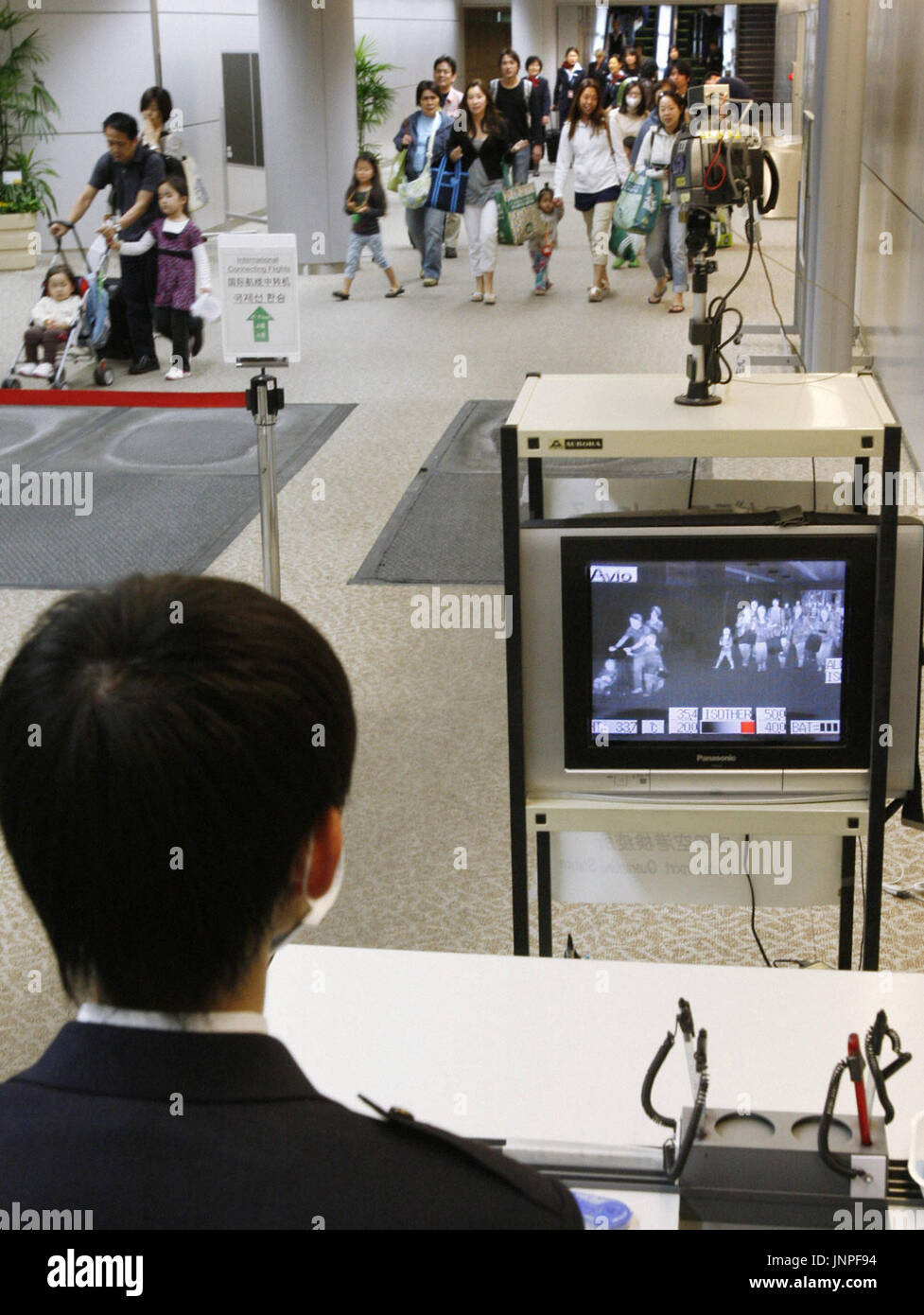 NARITA, Japan - A Japanese quarantine official awaits passengers ...