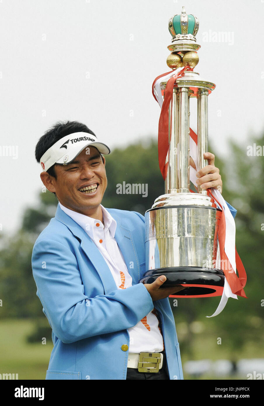 NAGOYA, Japan - Tetsuji Hiratsuka smiles with the winner's trophy after ...