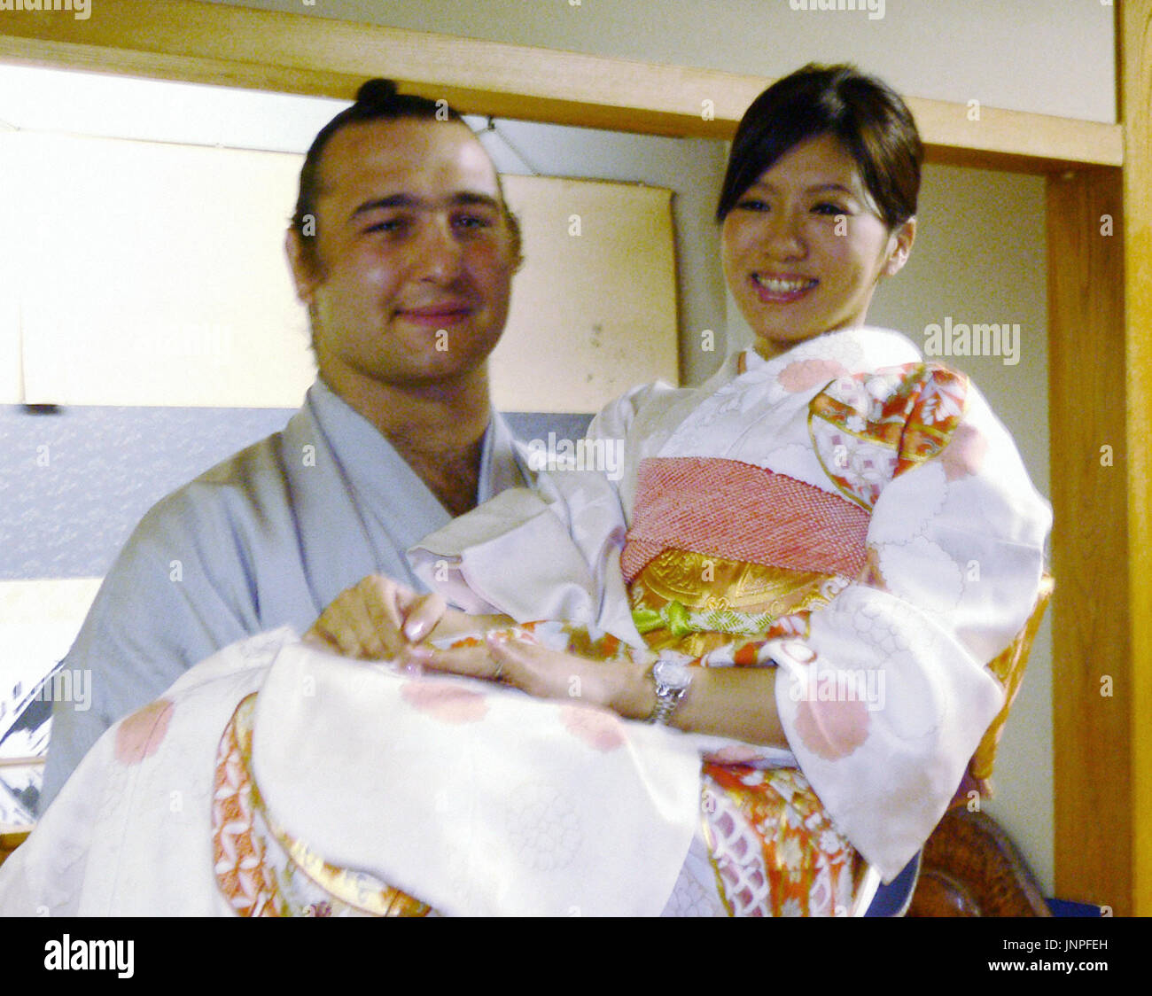 MATSUDO, Japan - Bulgarian ozeki Kotooshu raises his fiancee Asako Ando ...
