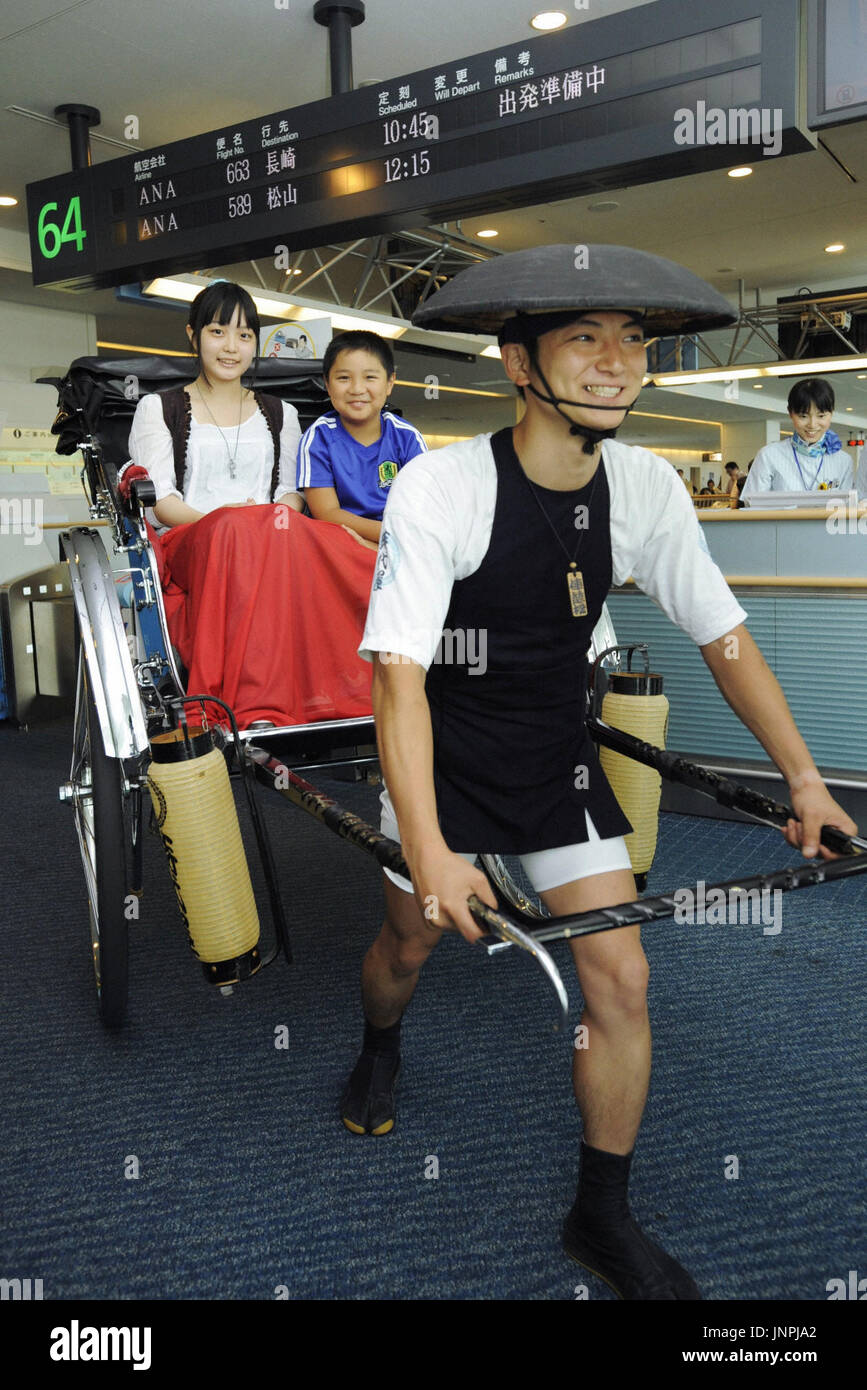 TOKYO, Japan - A rickshaw puller carries passengers to their flight at ...