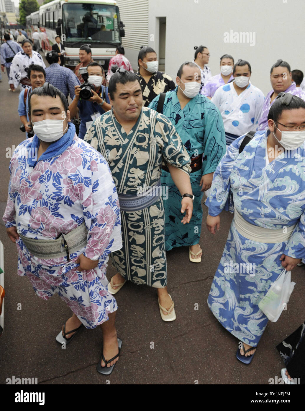 TOKYO, Japan - Sumo wrestlers, leaving Ryogoku Kokugikan in Tokyo on a ...