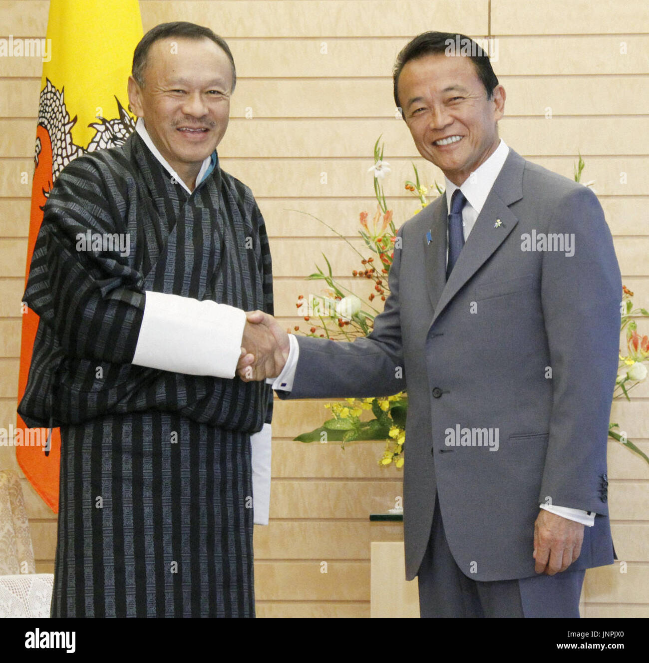 TOKYO, Japan - Japan's Prime Minister Taro Aso (R) shakes hands with Bhutan's Prime Minister ...