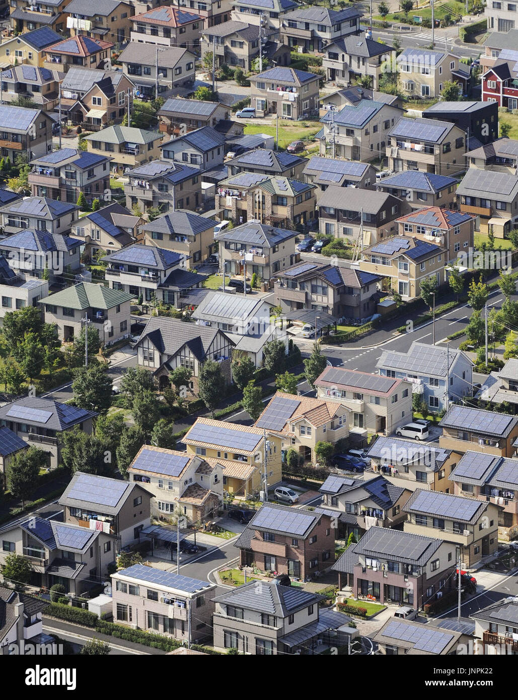 TOKYO, Japan - This photo shows houses equipped with solar roof panels ...
