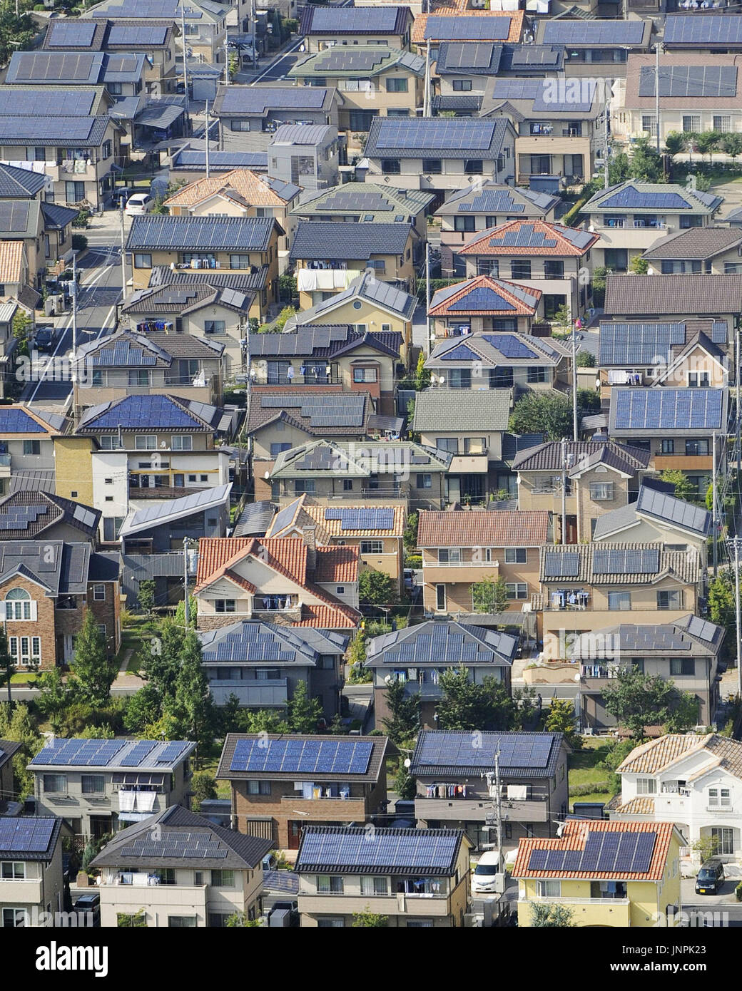 TOKYO, Japan - This photo shows houses equipped with solar roof panels ...