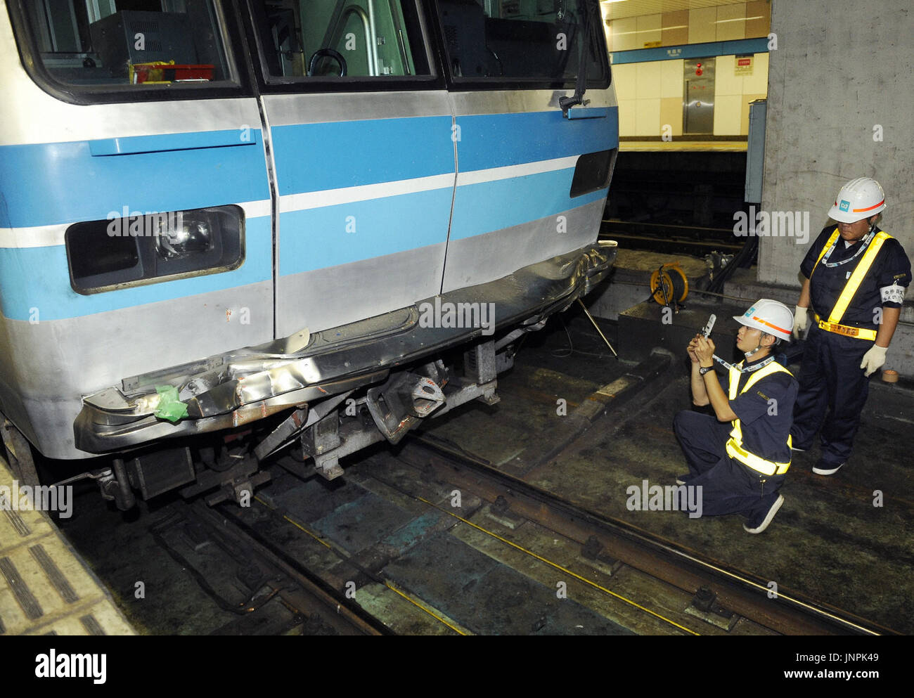 TOKYO, Japan - Tokyo Metro Co. employees check on a passenger train at ...