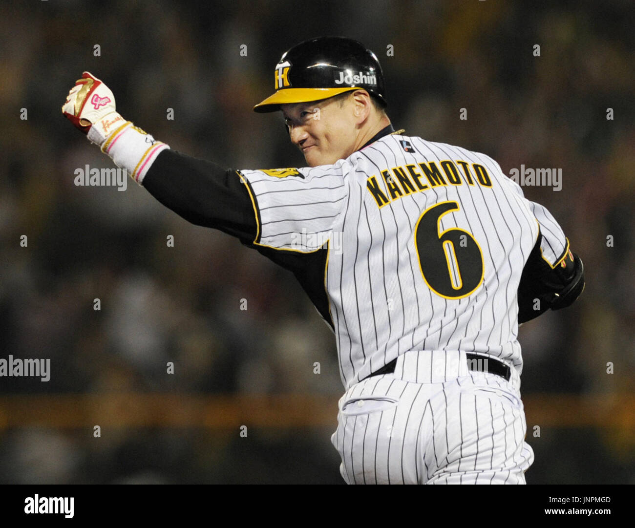 KOSHIEN, Japan - Hanshin Tigers veteran slugger Tomoaki Kanemoto reacts after hitting a game ...