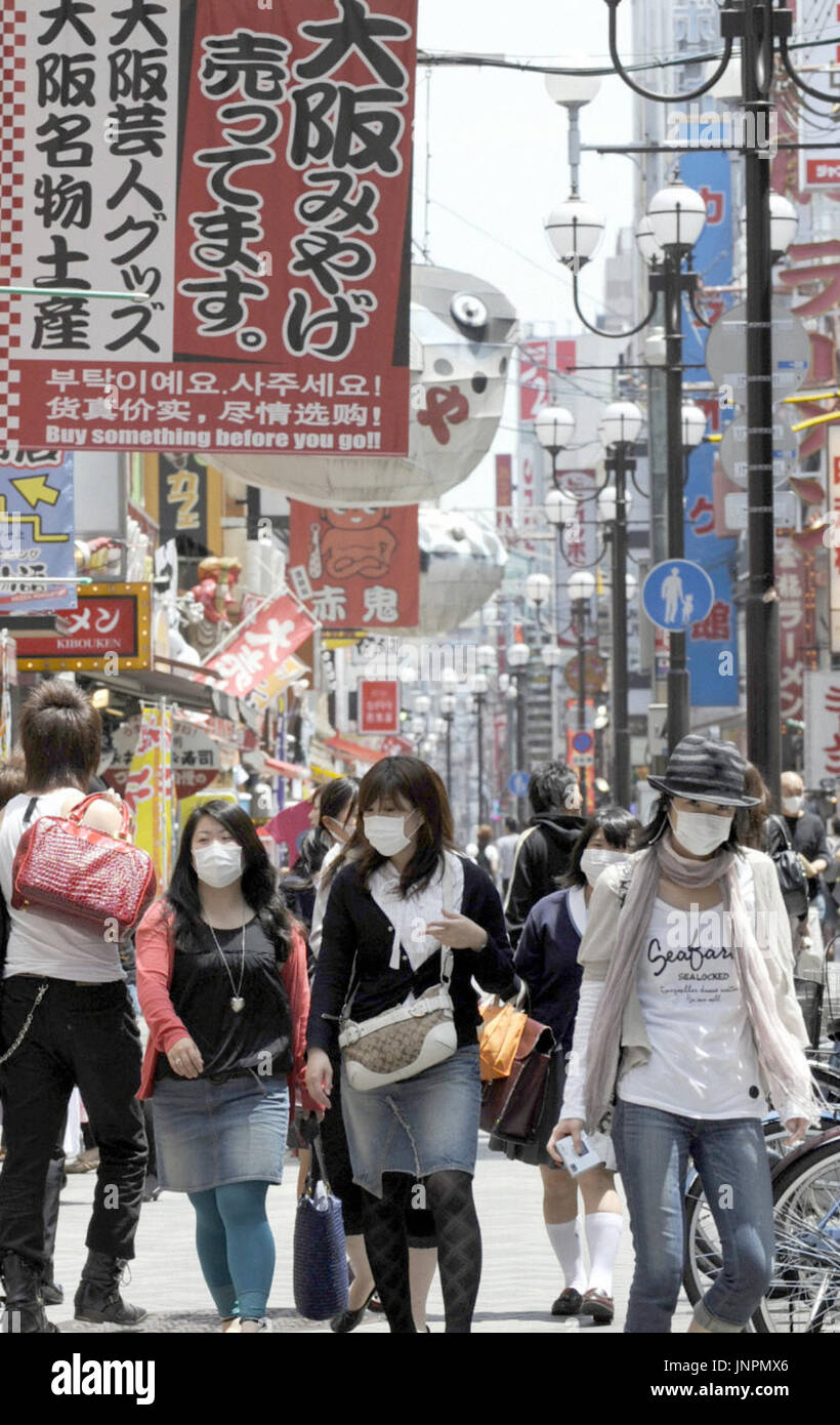 OSAKA, Japan - People wear masks in a shopping district in Osaka's ...