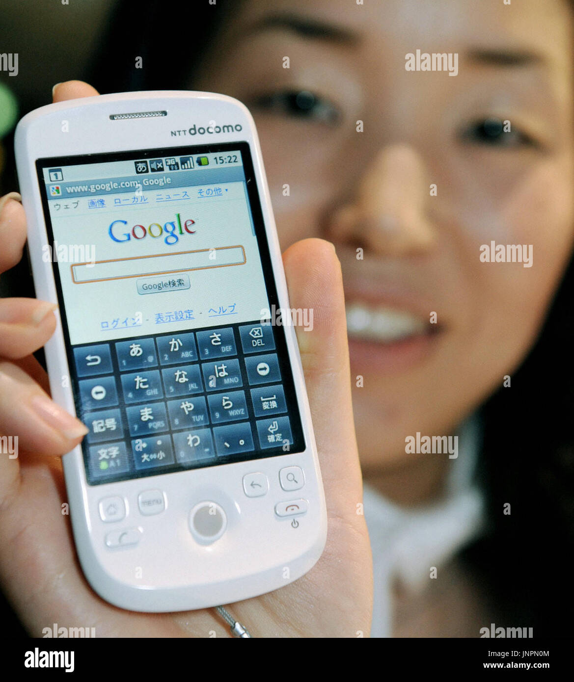 TOKYO, Japan - A model shows off Japan's first mobile phone to use ...