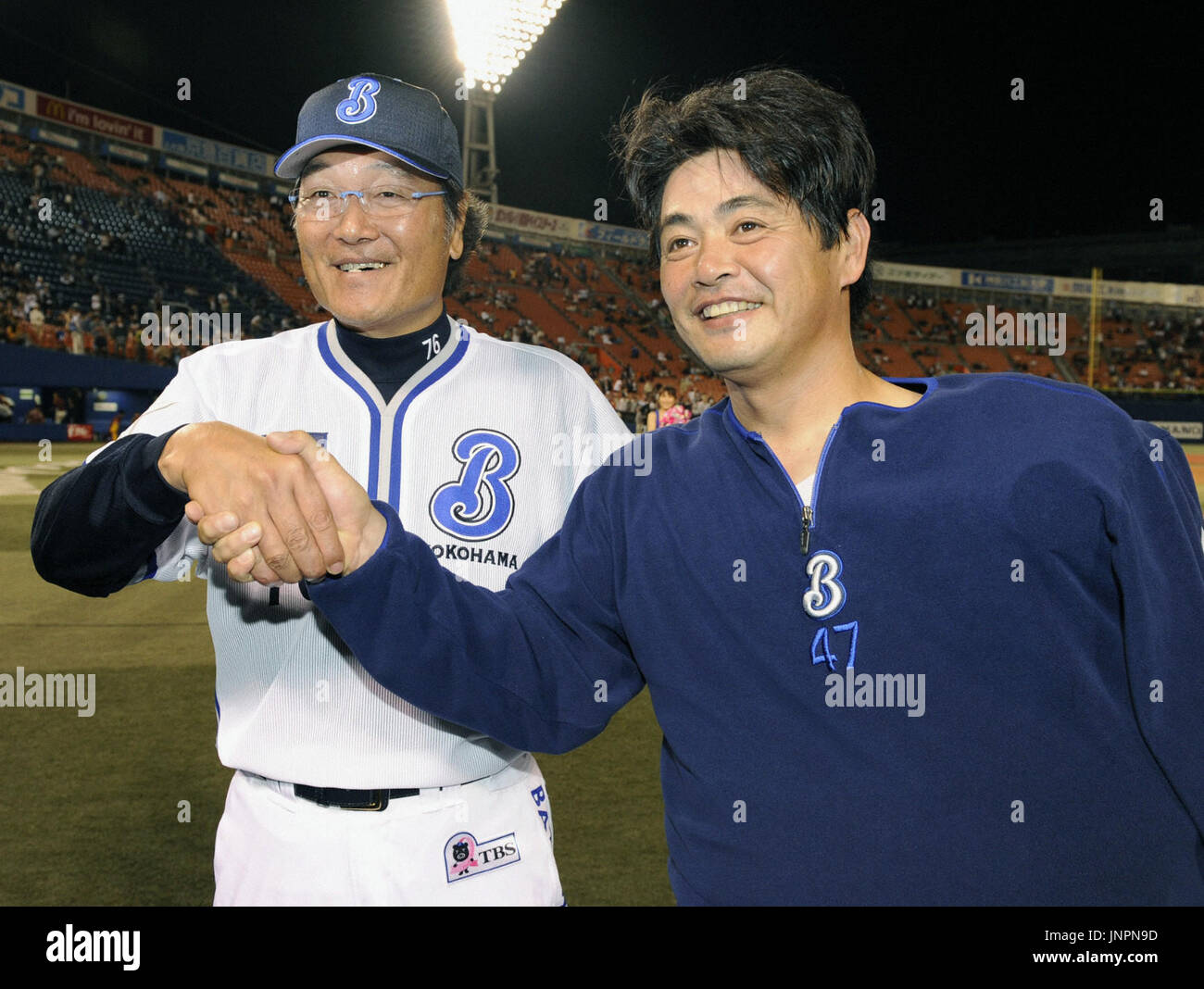 YOKOHAMA, Japan - Yokohama BayStars veteran pitcher Kimiyasu Kudo shakes hands with the club's ...