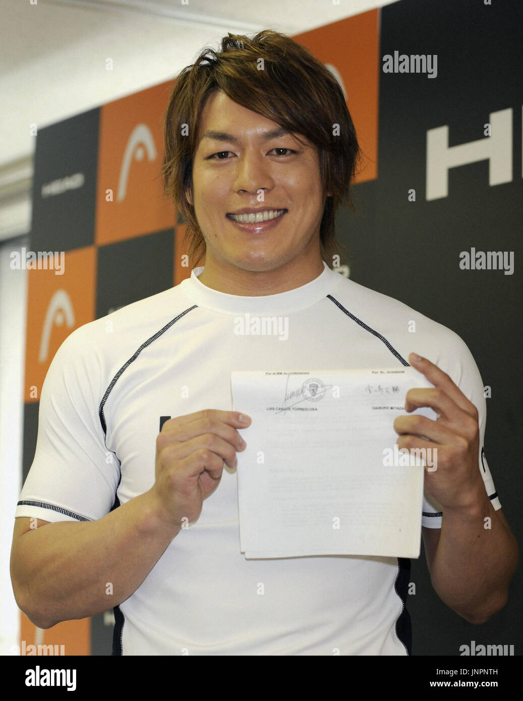 TOKYO, Japan - Top Japanese handball player Daisuke Miyazaki shows his one-year contract with ...