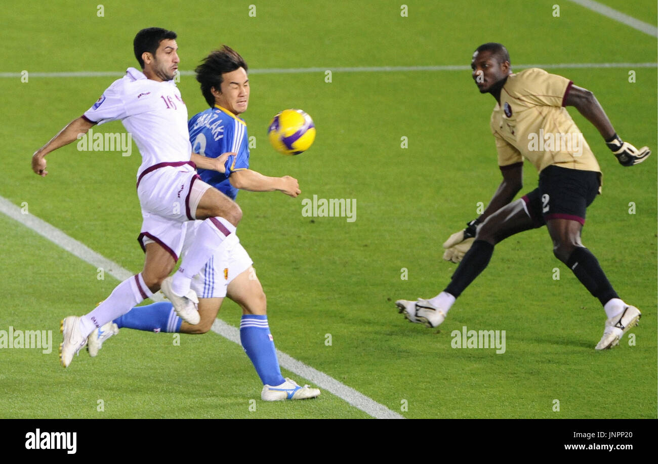 YOKOHAMA, Japan - Qatar's Ahmed Ali Albinali (L) inadvertently deflects ...