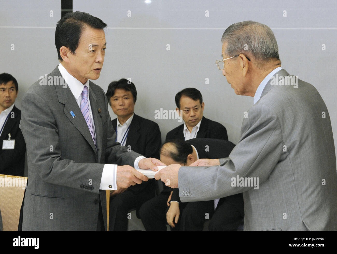 TOKYO, Japan - Yutaka Narita (R), head of a government expert panel ...