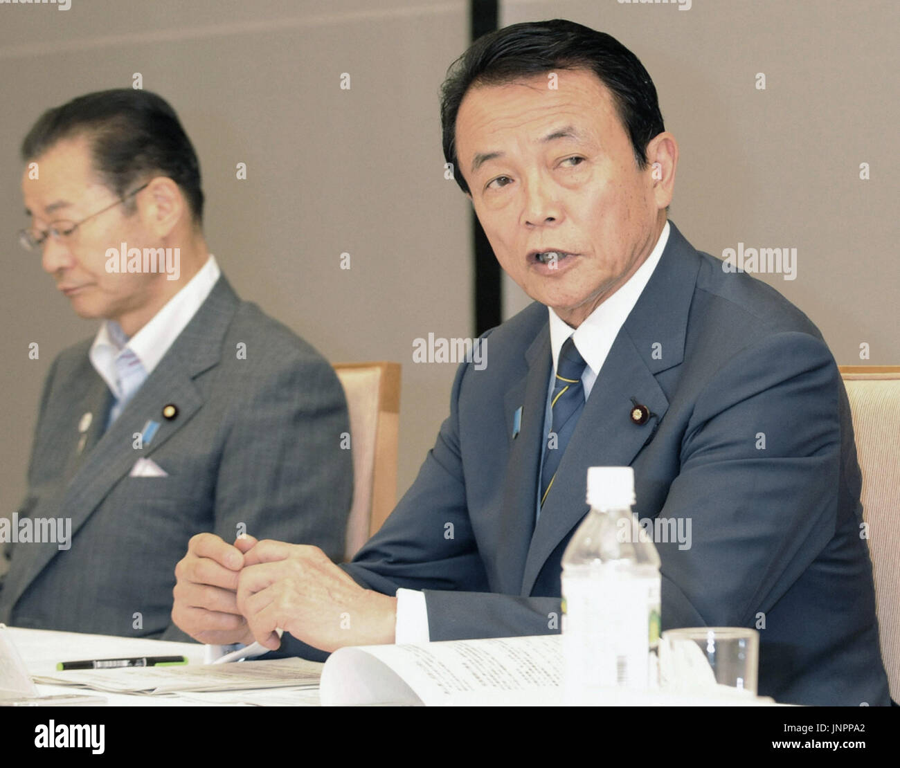 TOKYO, Japan - Prime Minister Taro Aso (R) addresses a meeting of the ...