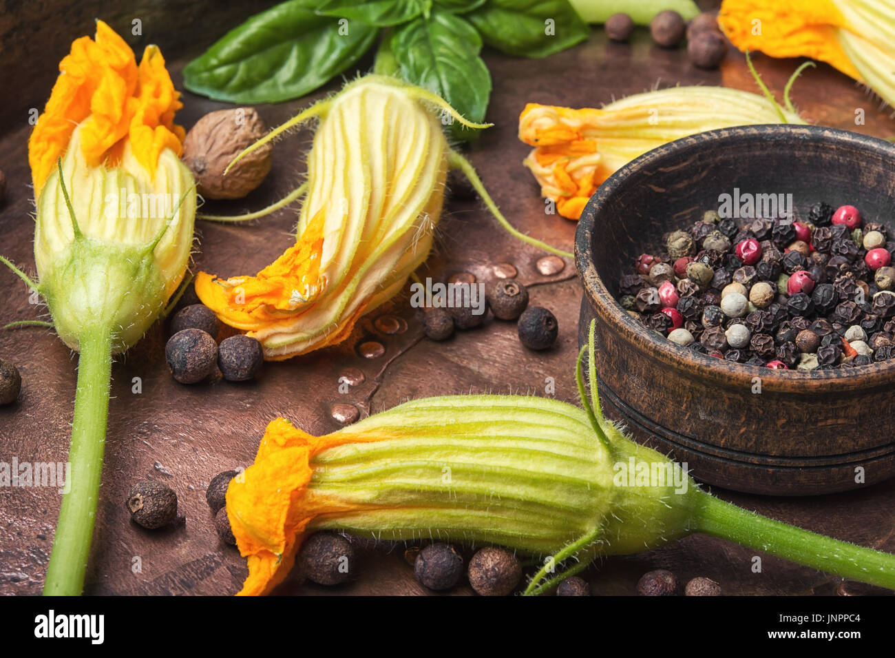 Edible pumpkin flowers with spice on a retro background Stock Photo - Alamy